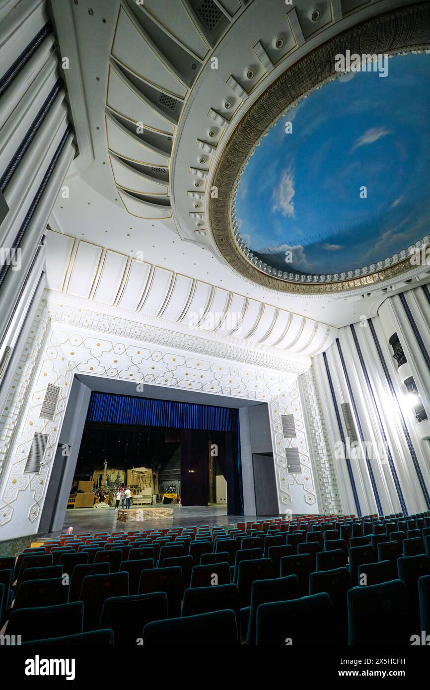 A view of the auditorium seats, looking up at the round, circular blue ...
