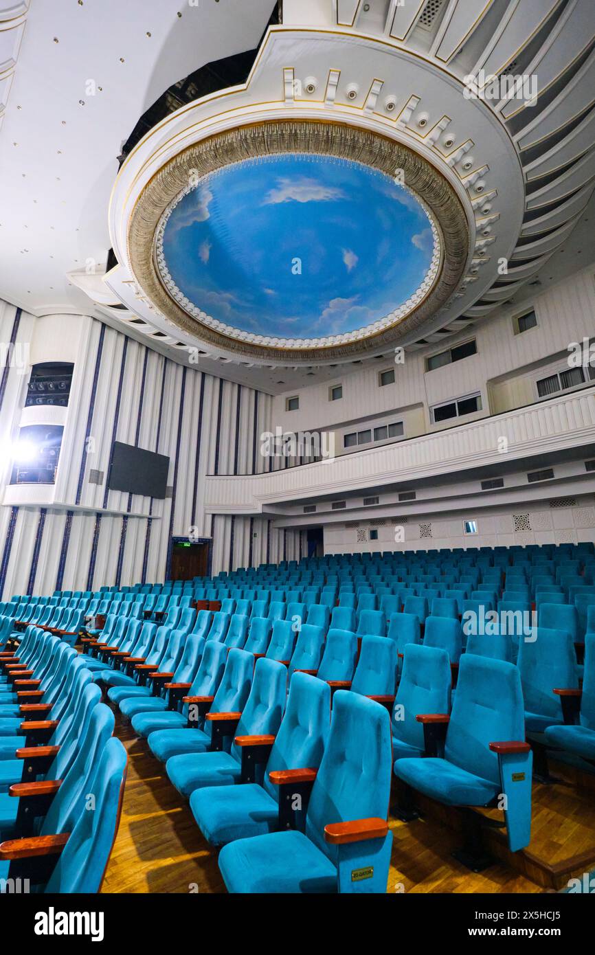 A view of the auditorium seats, looking up at the round, circular blue ...