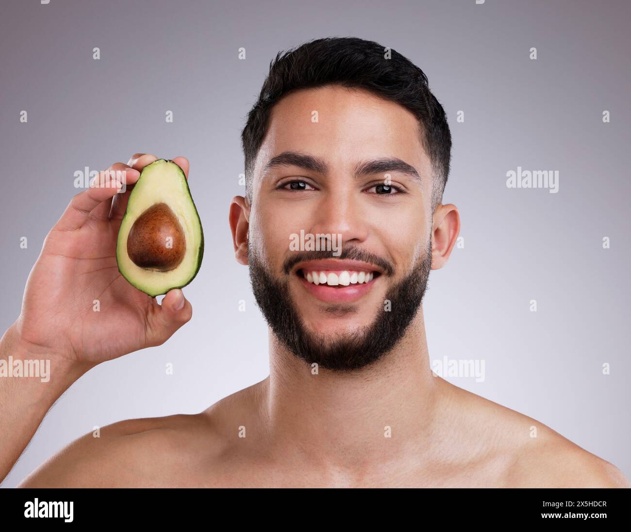 Studio, portrait and man with avocado, skincare and smile with ...