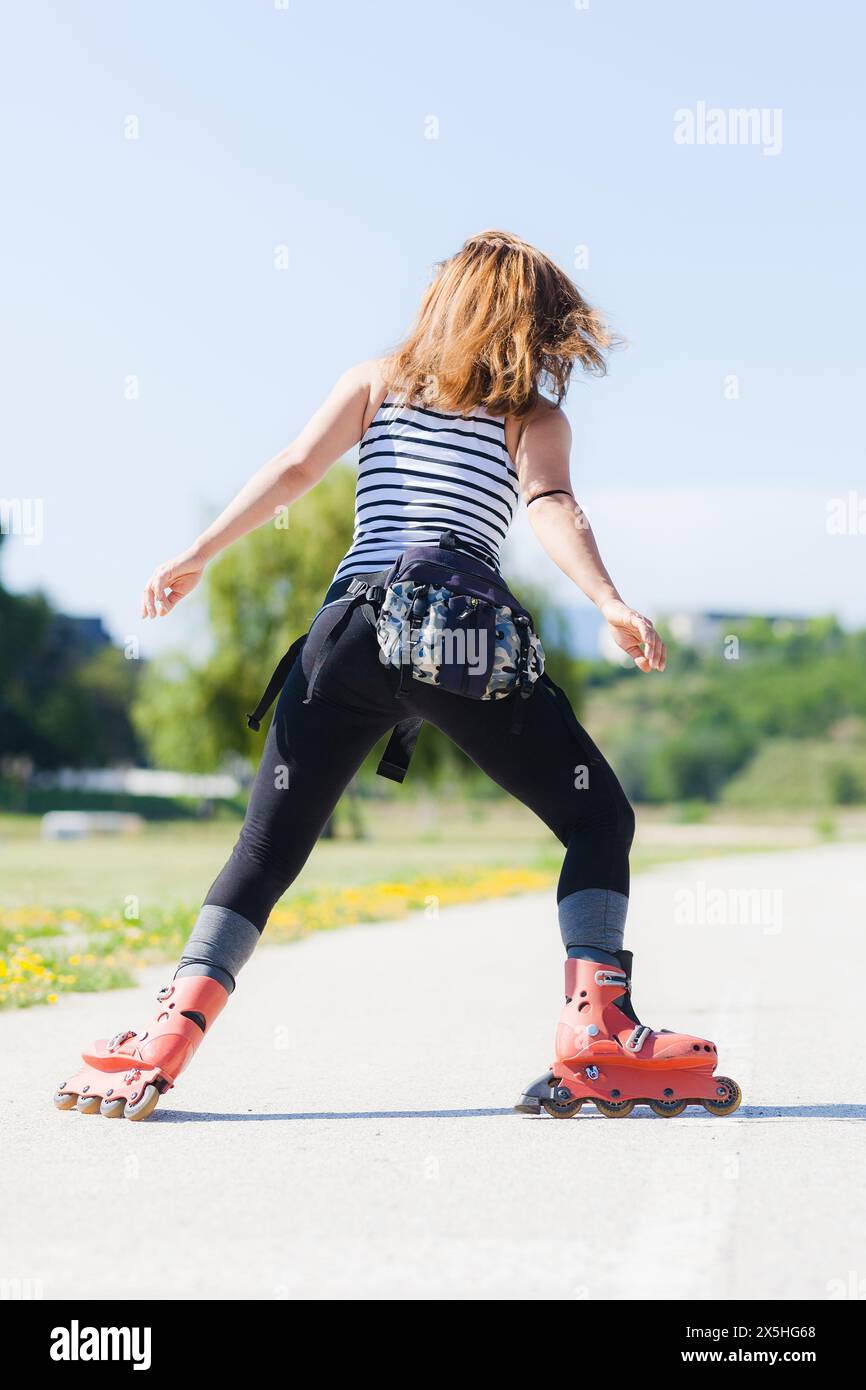 Woman enjoying activity rollerblading along hi-res stock photography ...