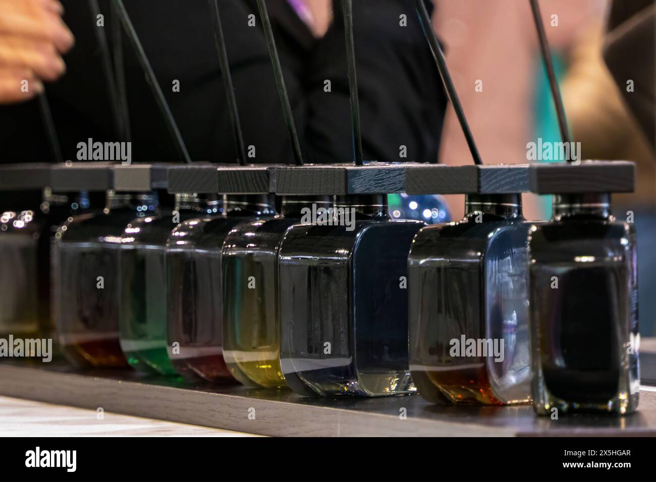 An array of multicolored perfume bottles lined up, showcasing variety ...