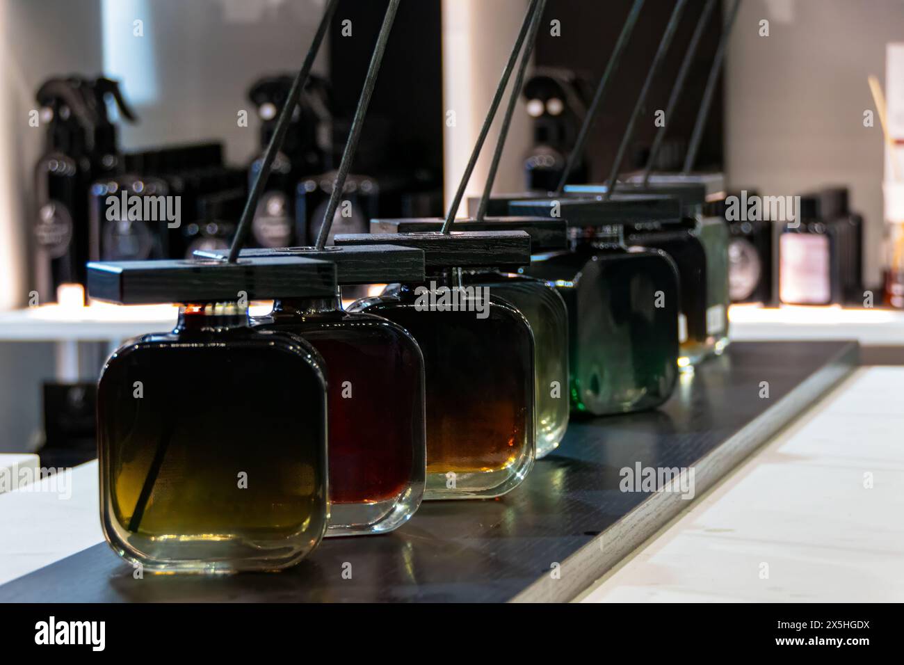 An array of multicolored perfume bottles lined up, showcasing variety ...