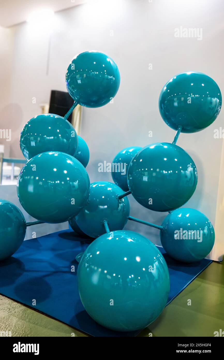 An exhibition of blue balls arranged in the shape of a crystal. The ...
