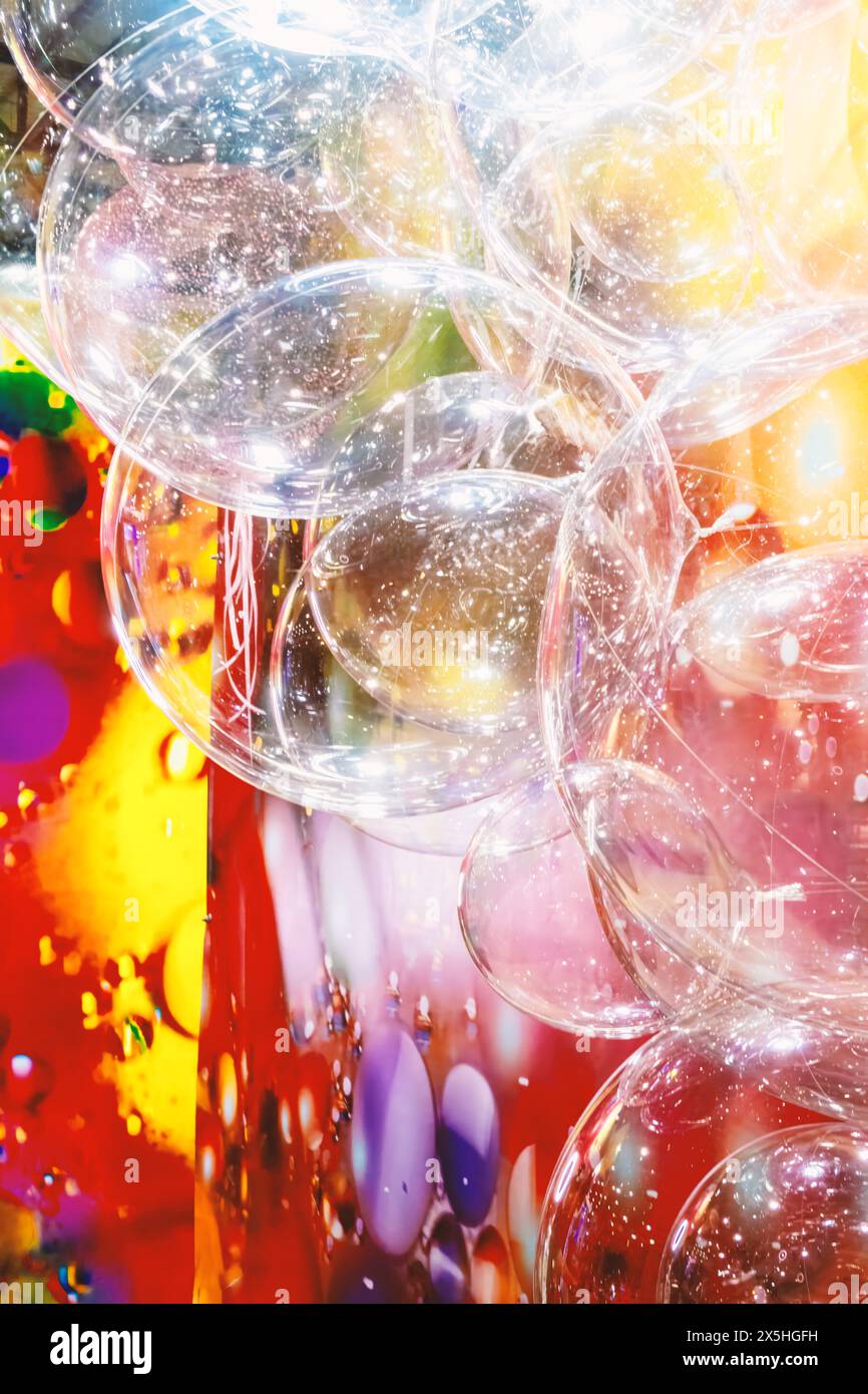 A large number of transparent plastic bubbles floating in the air. The ...