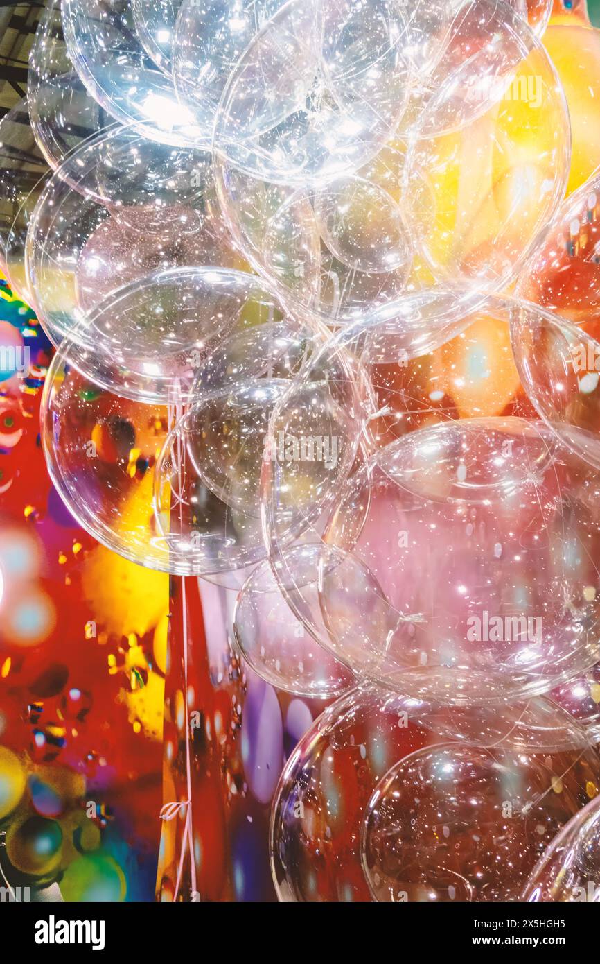 A large number of transparent plastic bubbles floating in the air. The ...