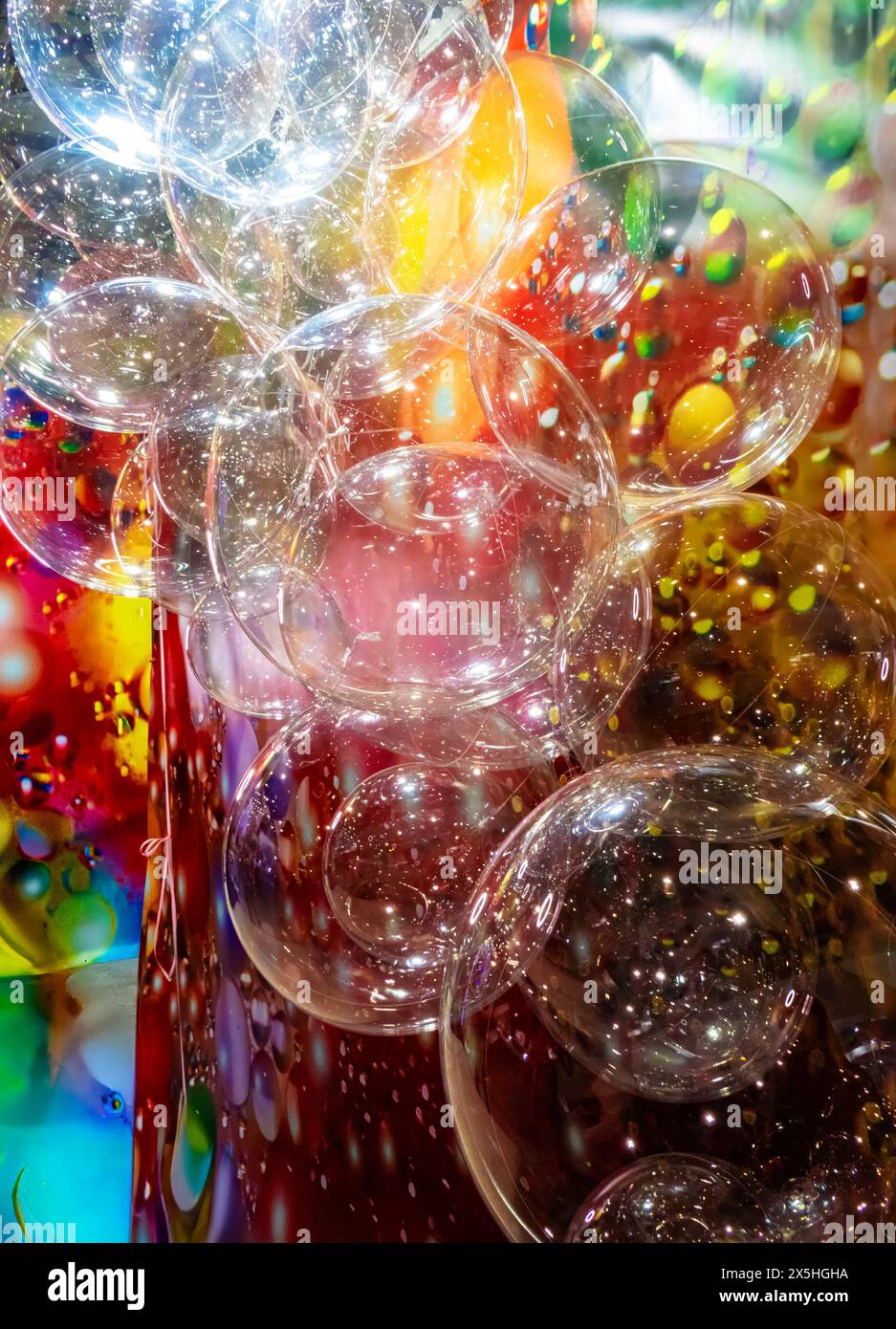 A large number of transparent plastic bubbles floating in the air. The ...