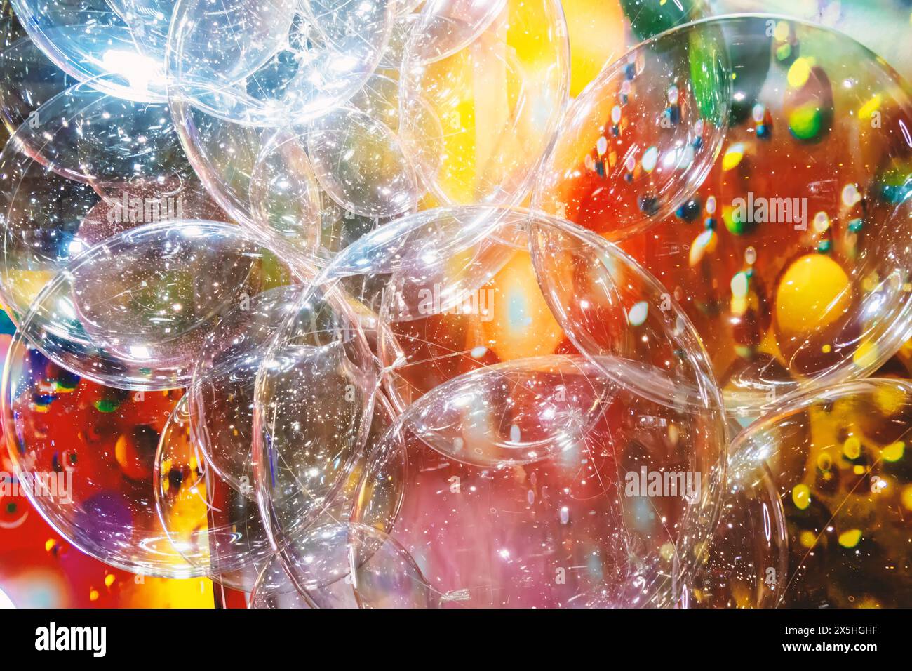 A large number of transparent plastic bubbles floating in the air. The ...