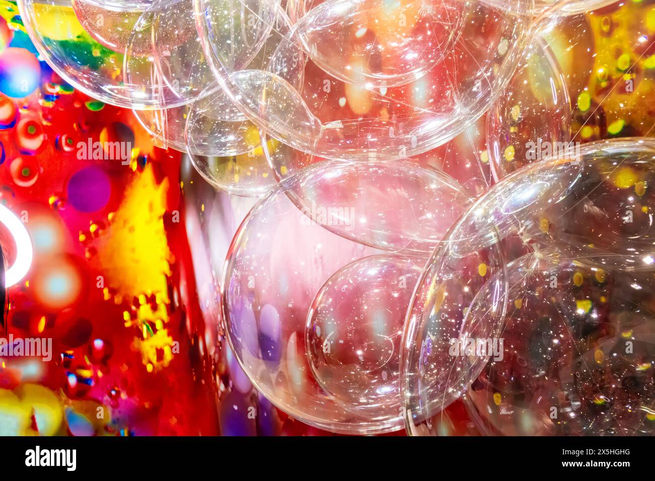 A large number of transparent plastic bubbles floating in the air. The ...