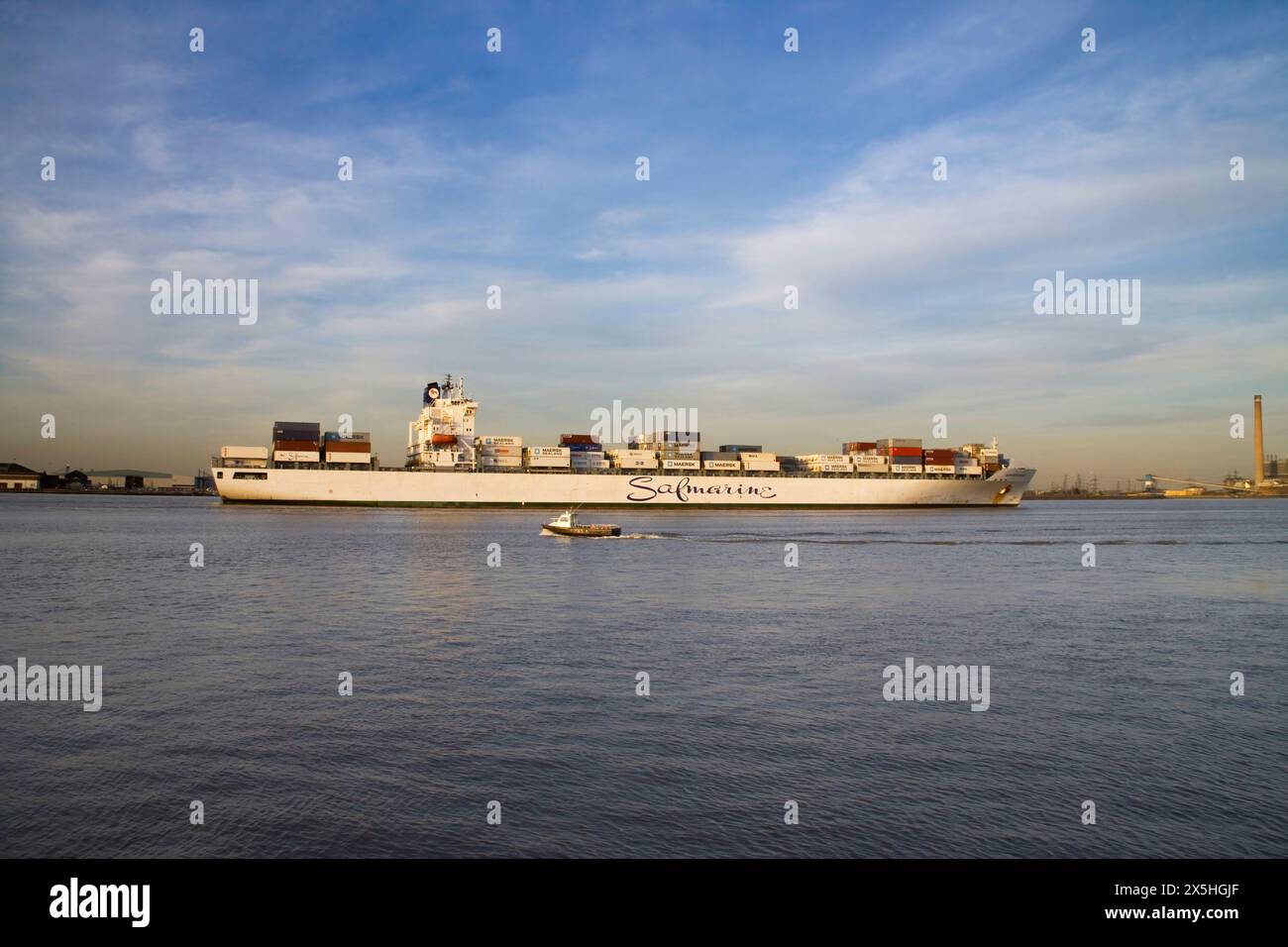 container ship leaving london and passing gravesend on the river Thames ...