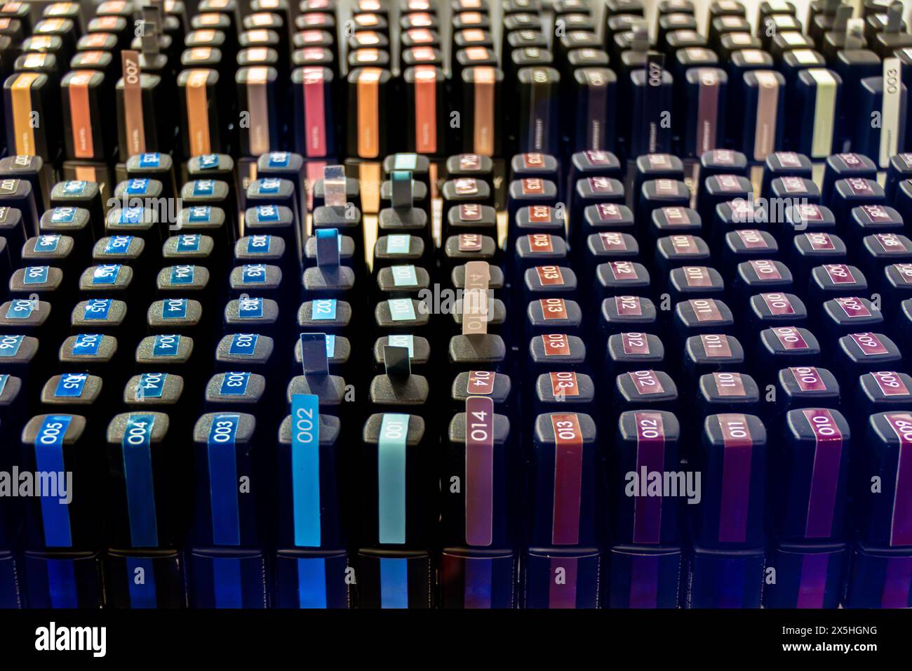 A large display case with many jars of nail polish of different colors ...