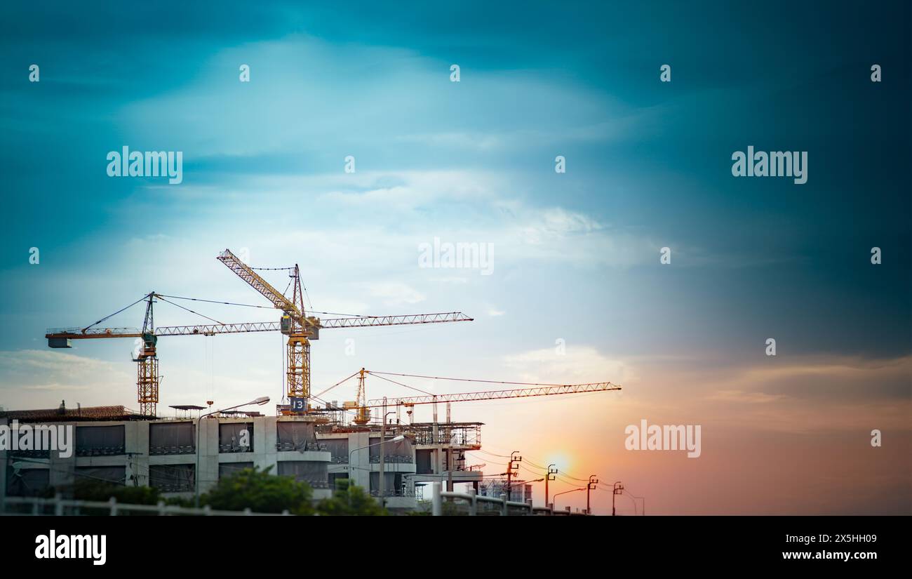 about 3 tower cranes installed at a construction site to build the city and blue sky Stock Photo ...