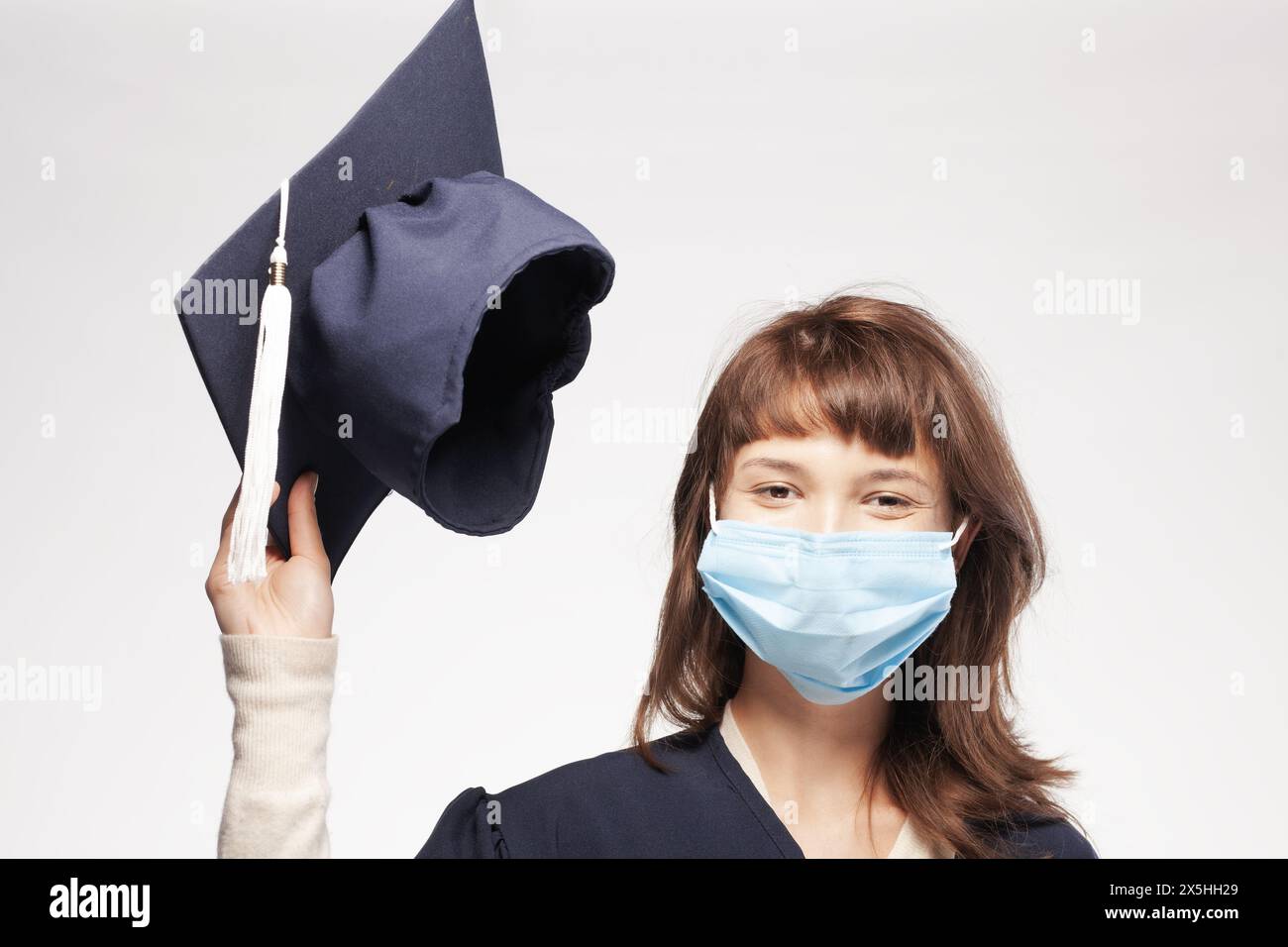 Graduation girl with gown throwing cap smiling. Happy female student ...