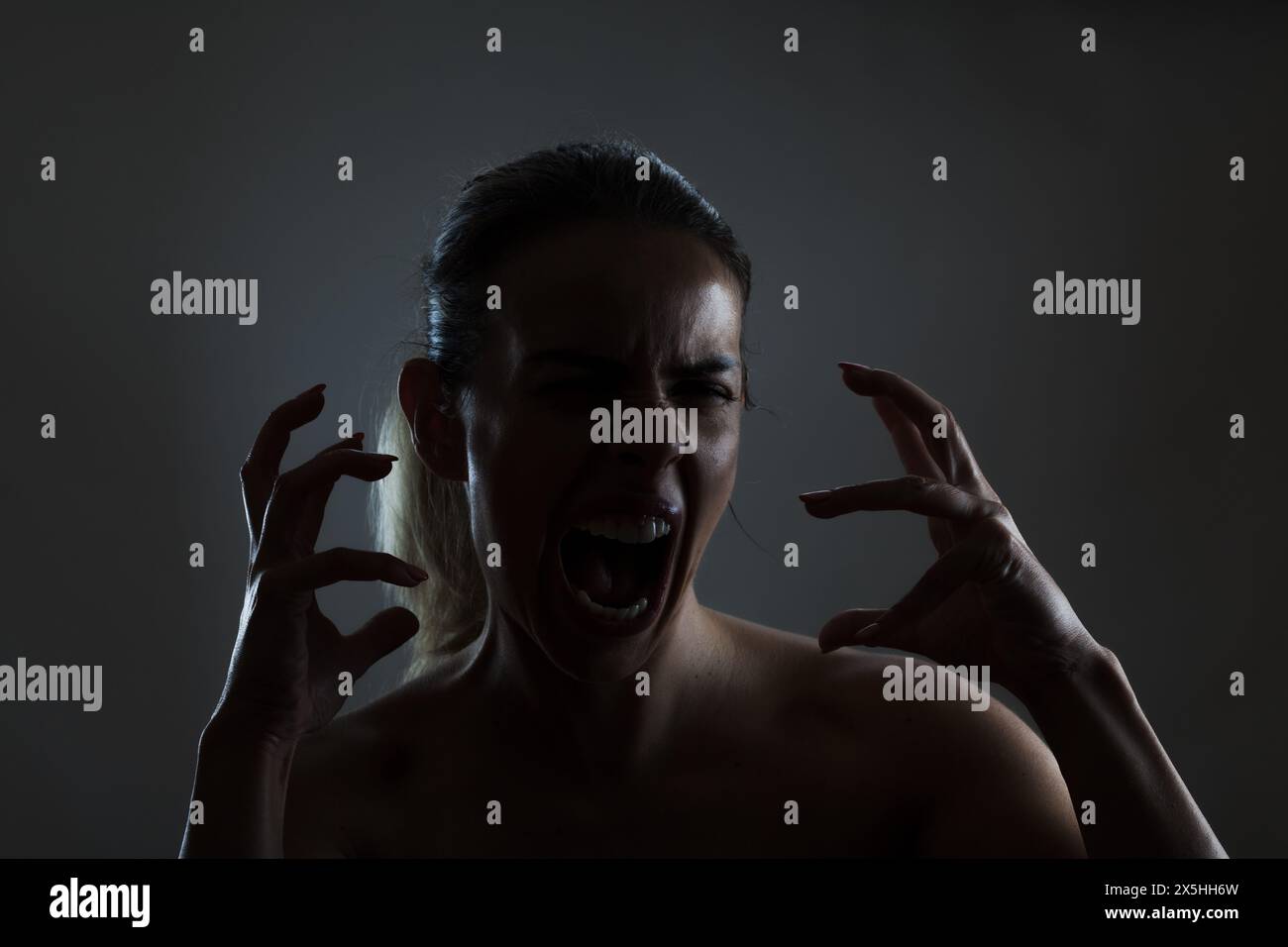 Dramatic image capturing the intense emotion of a woman screaming with ...
