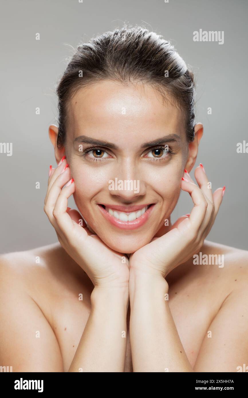 This image captures a young woman's radiant smile and sparkling eyes ...