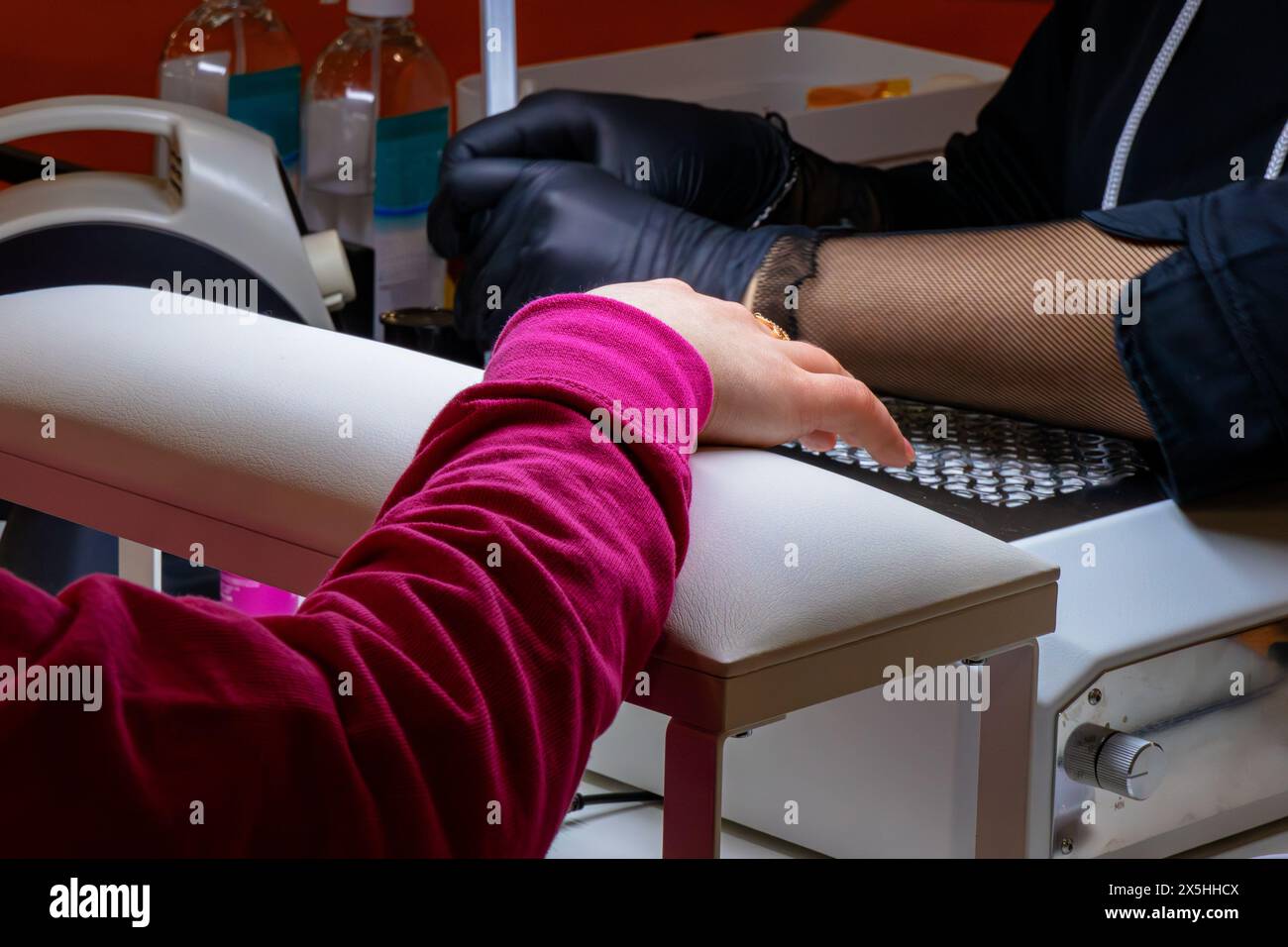 A makeup artist does a manicure on the nails of his client Stock Photo ...