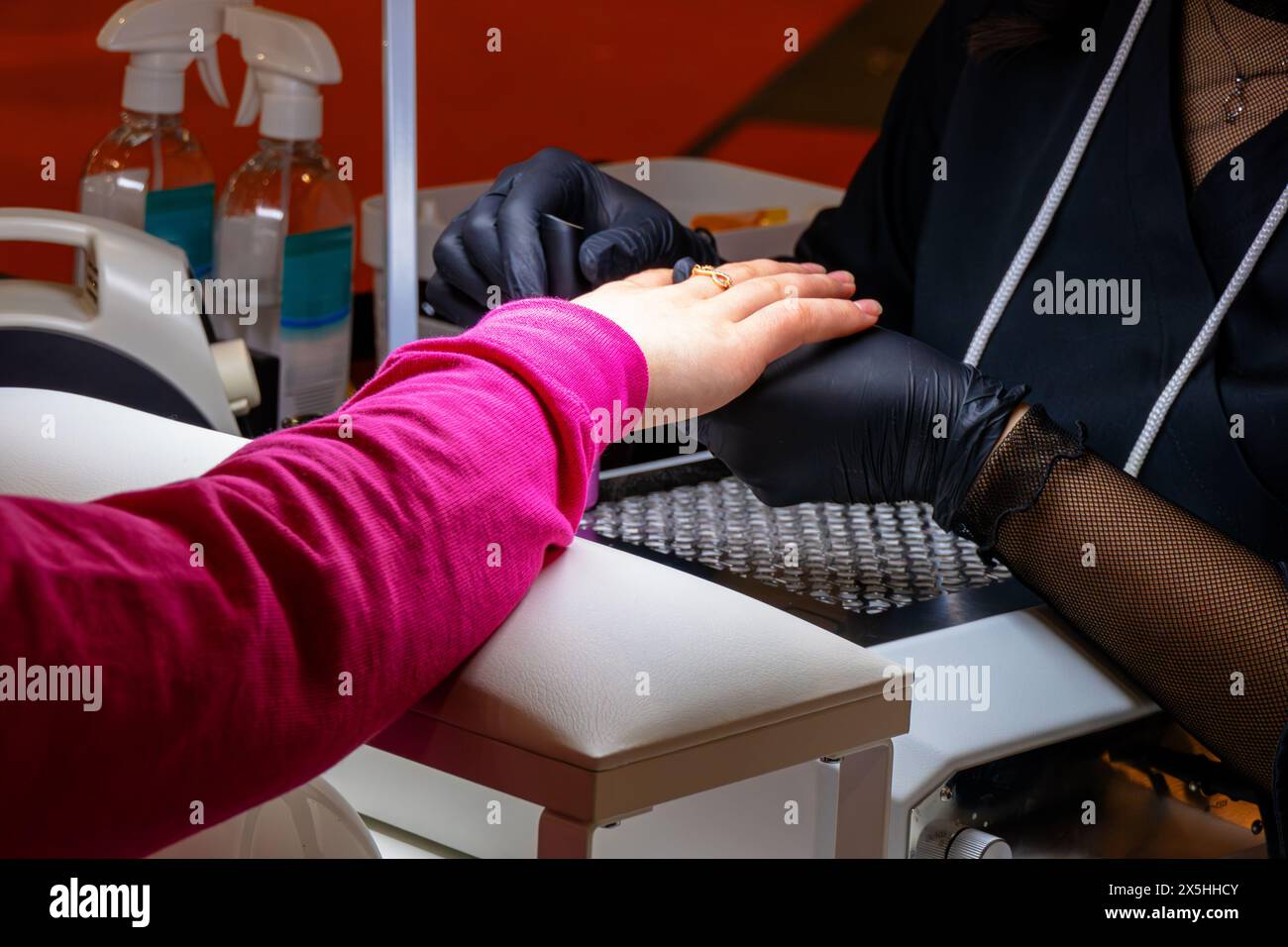 A makeup artist does a manicure on the nails of his client Stock Photo ...