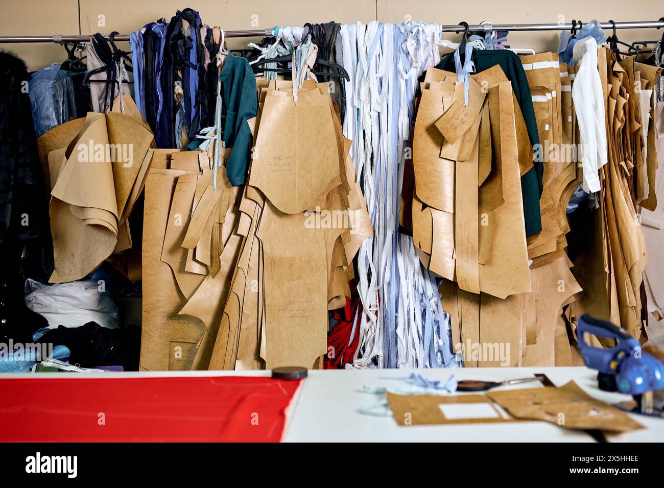 room of fashion designer, garments ready for embroidery in textile ...