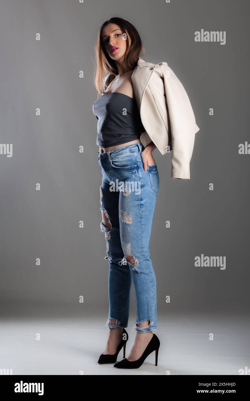 full body poirtrait of a beautiful girl with long hair wearing jeans ...