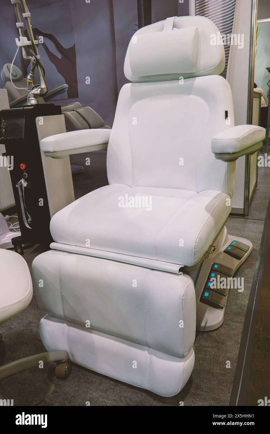 Cosmetology salon with a chair for clients and a white chair for the ...