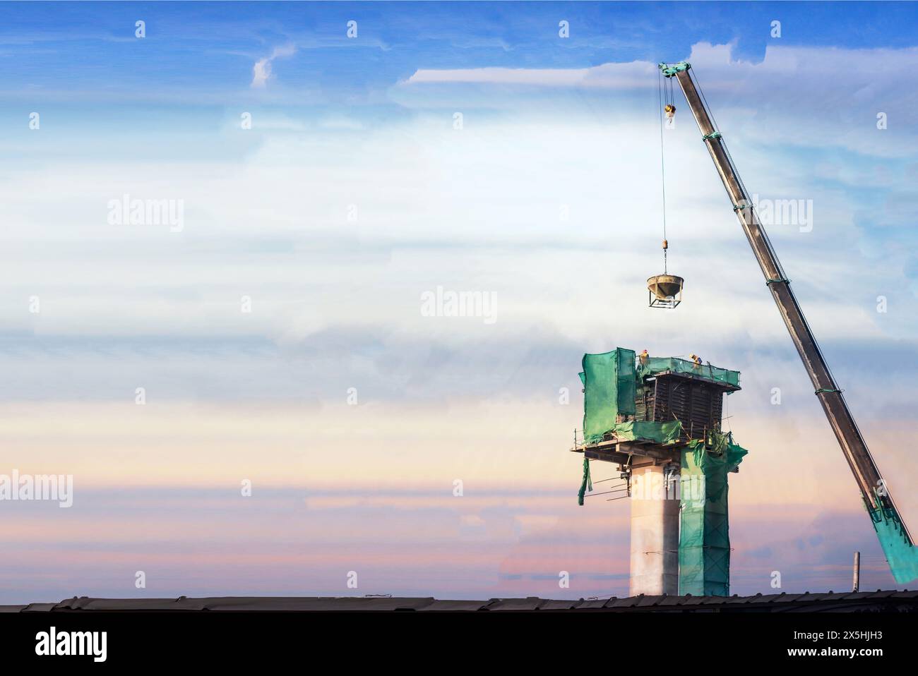 Build a bridge using a crane to lift concrete on a construction site ...