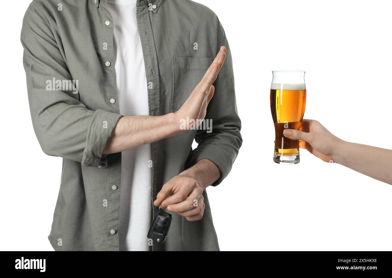 Man with car keys refusing alcohol while woman suggesting him beer on ...