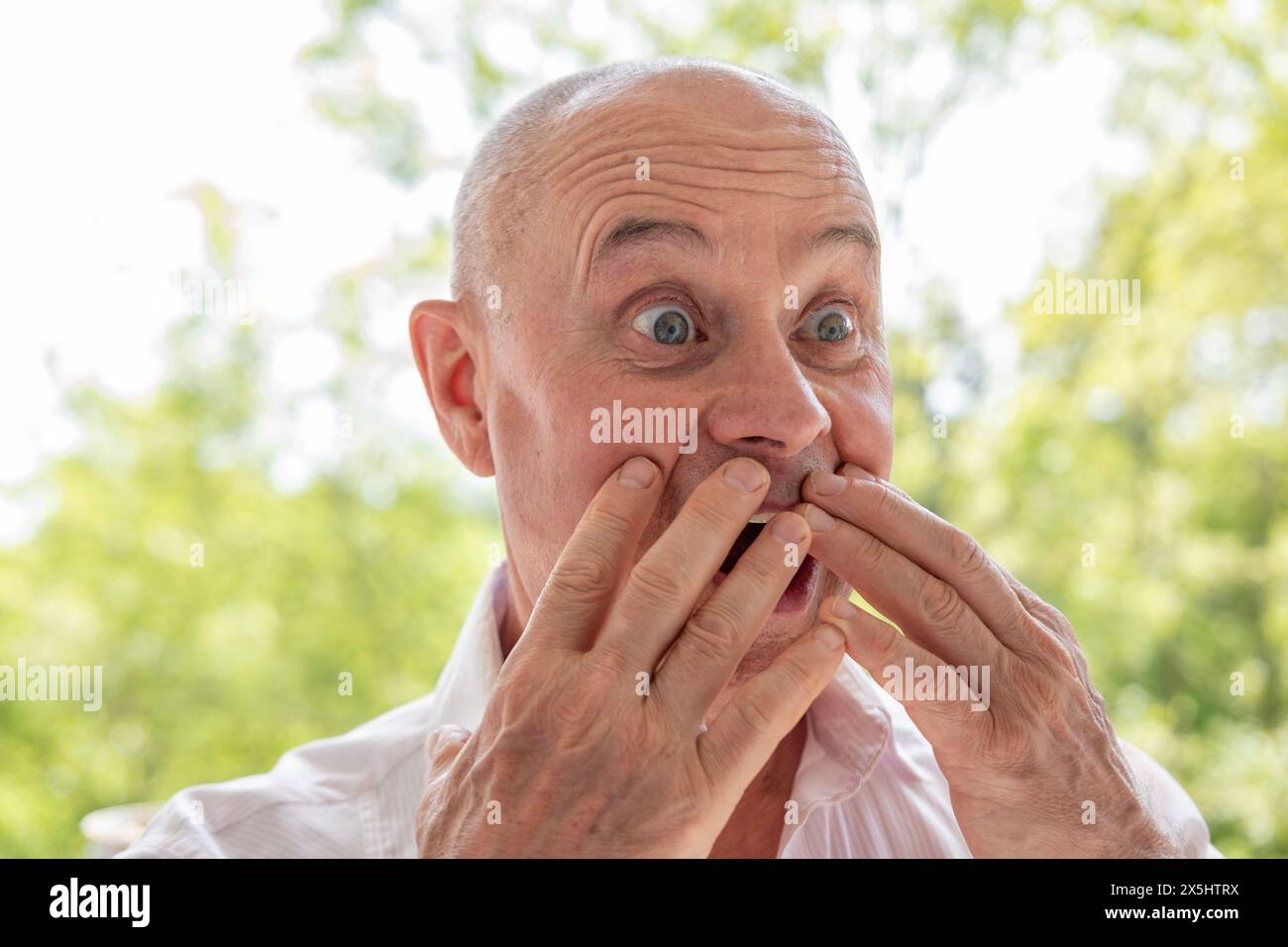 65-year-old eccentric man very surprised, senior showing grimaces ...