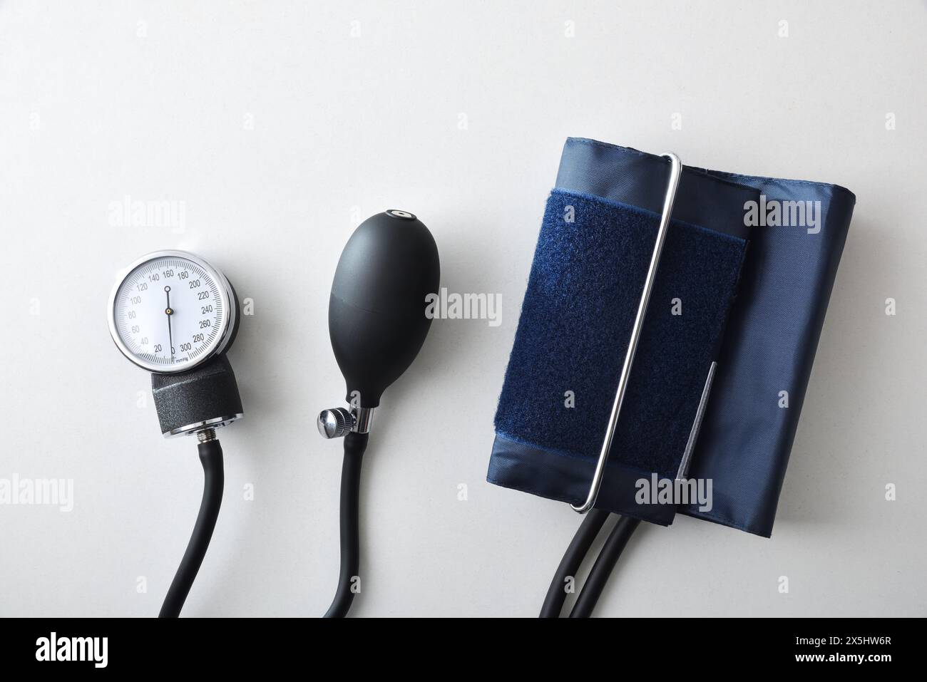 Detail of manual blood pressure monitor with blue cuff isolated on ...