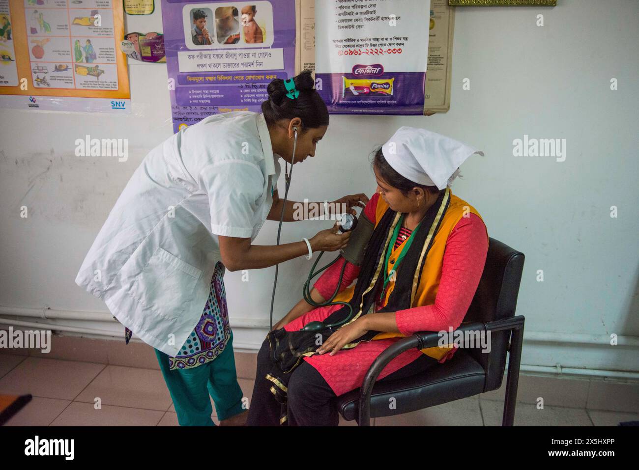 South Asia, Bangladesh, Dhaka. A factory worker receives a health check ...