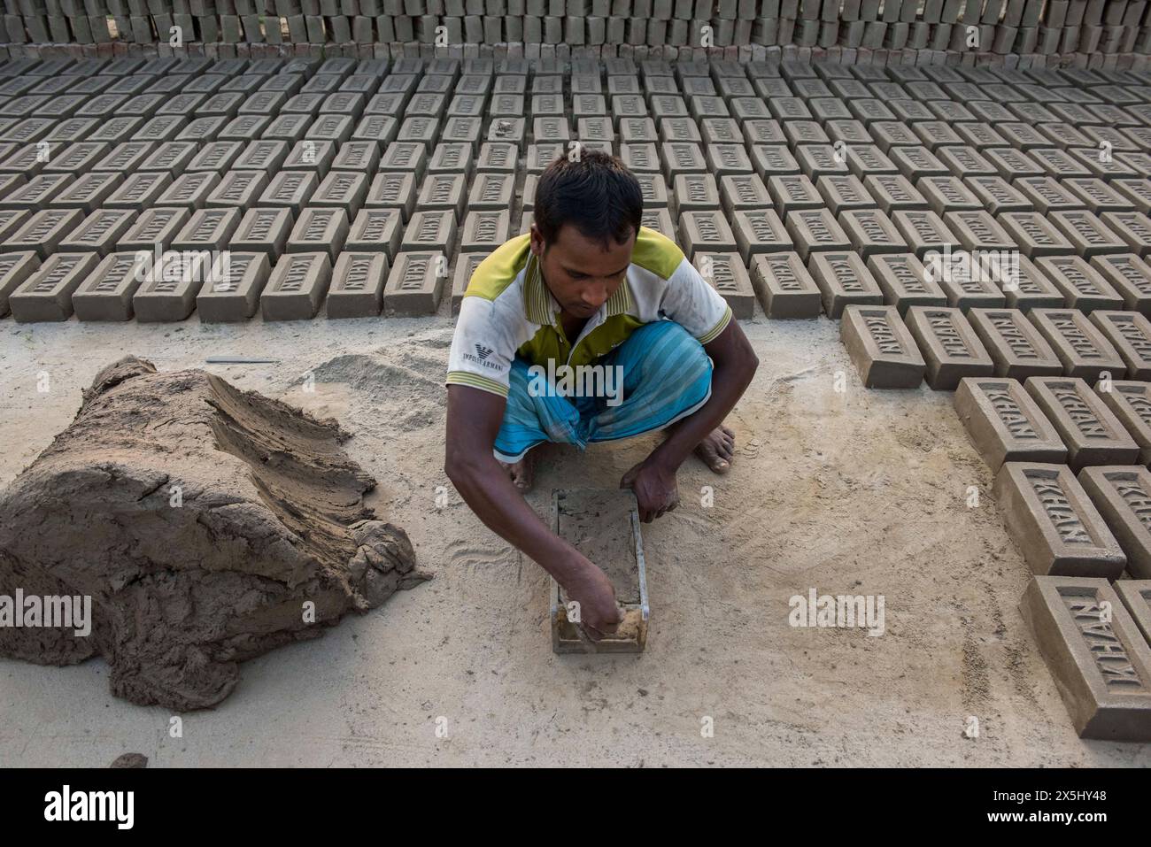 Bangladesh, Jhenaidah. A man makes bricks in a factory in Bangladesh ...