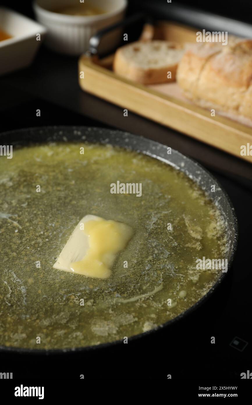 Melting butter in frying pan on table Stock Photo - Alamy