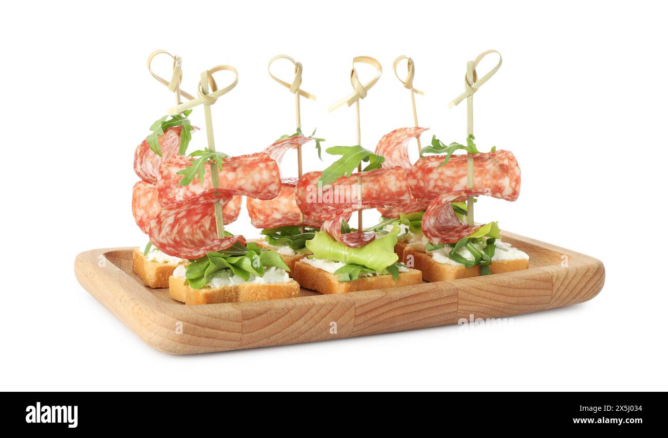 Tasty canapes with salami, greens and cream cheese isolated on white ...