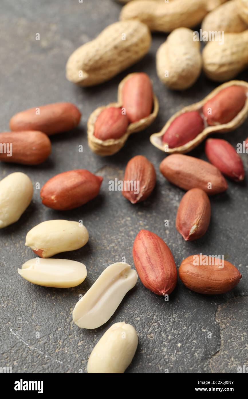 Fresh peanuts on grey table. Healthy snack Stock Photo - Alamy
