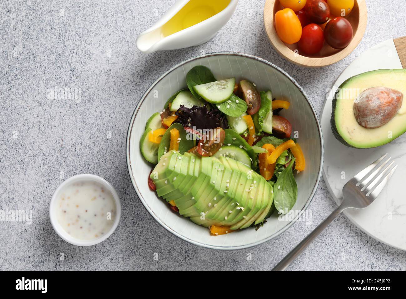 Healthy dish high in vegetable fats served on light textured table ...
