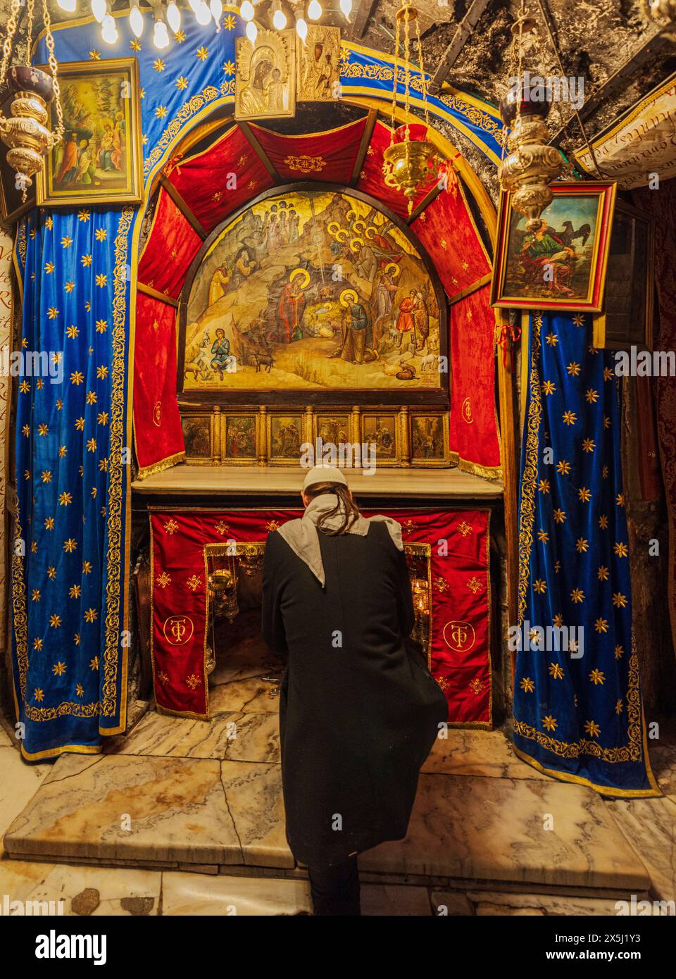 Israel, Bethlehem. Praying inside the Church of the Nativity, where ...