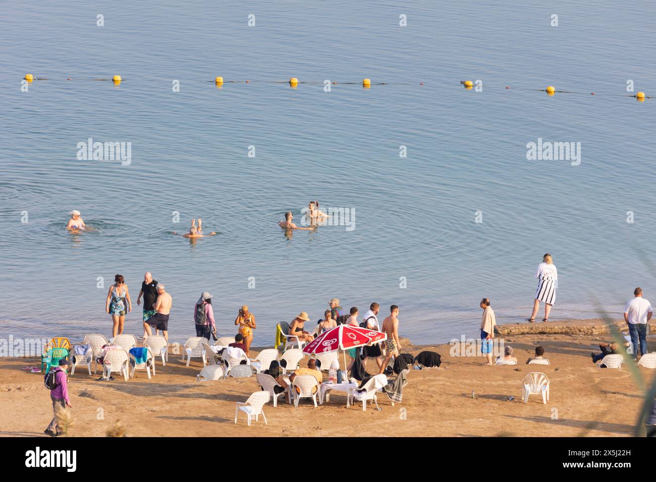 Israel. The Dead Sea swimmers. Floating on their back due to the high ...