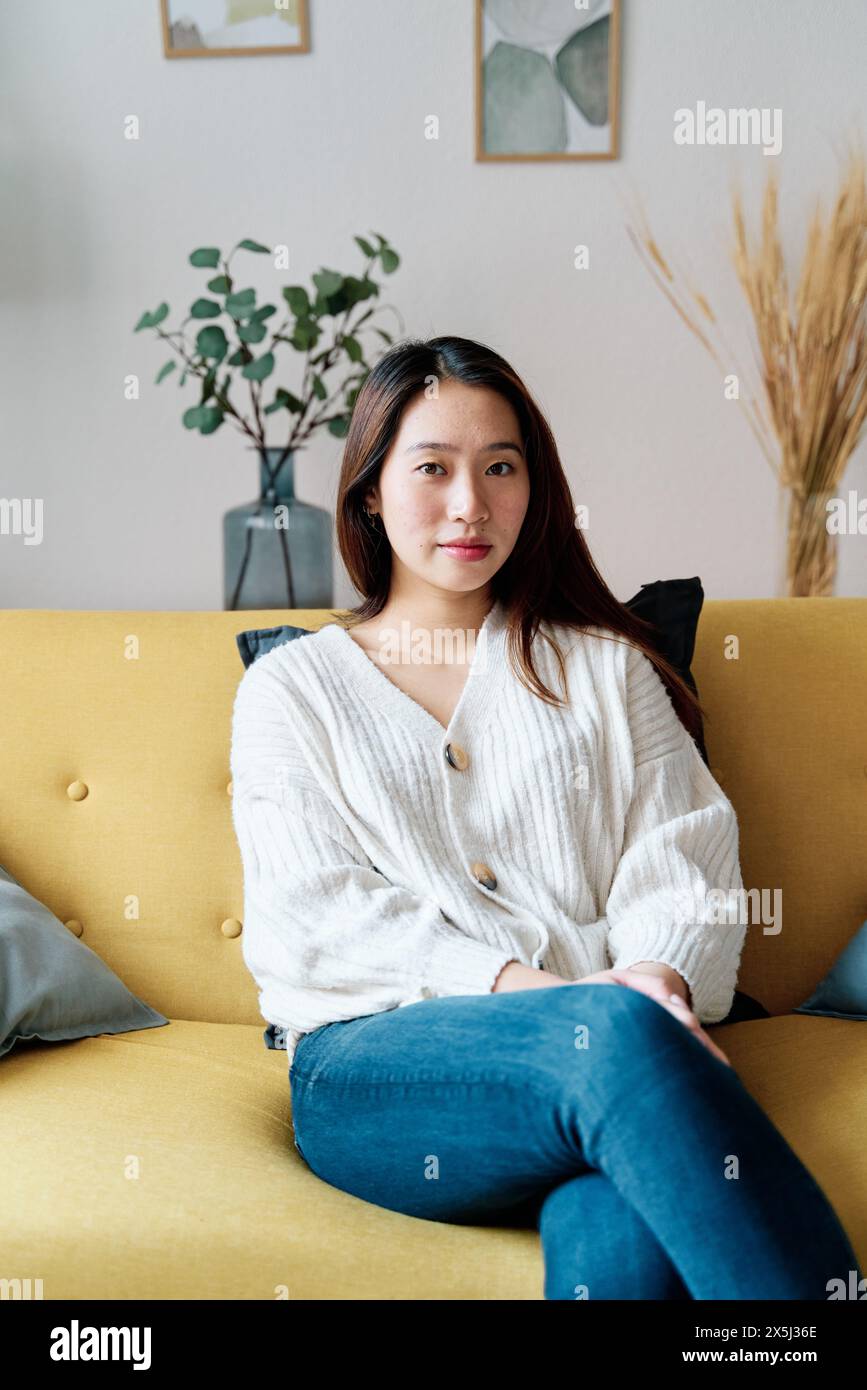 Woman comfortably seated on couch hi-res stock photography and images ...