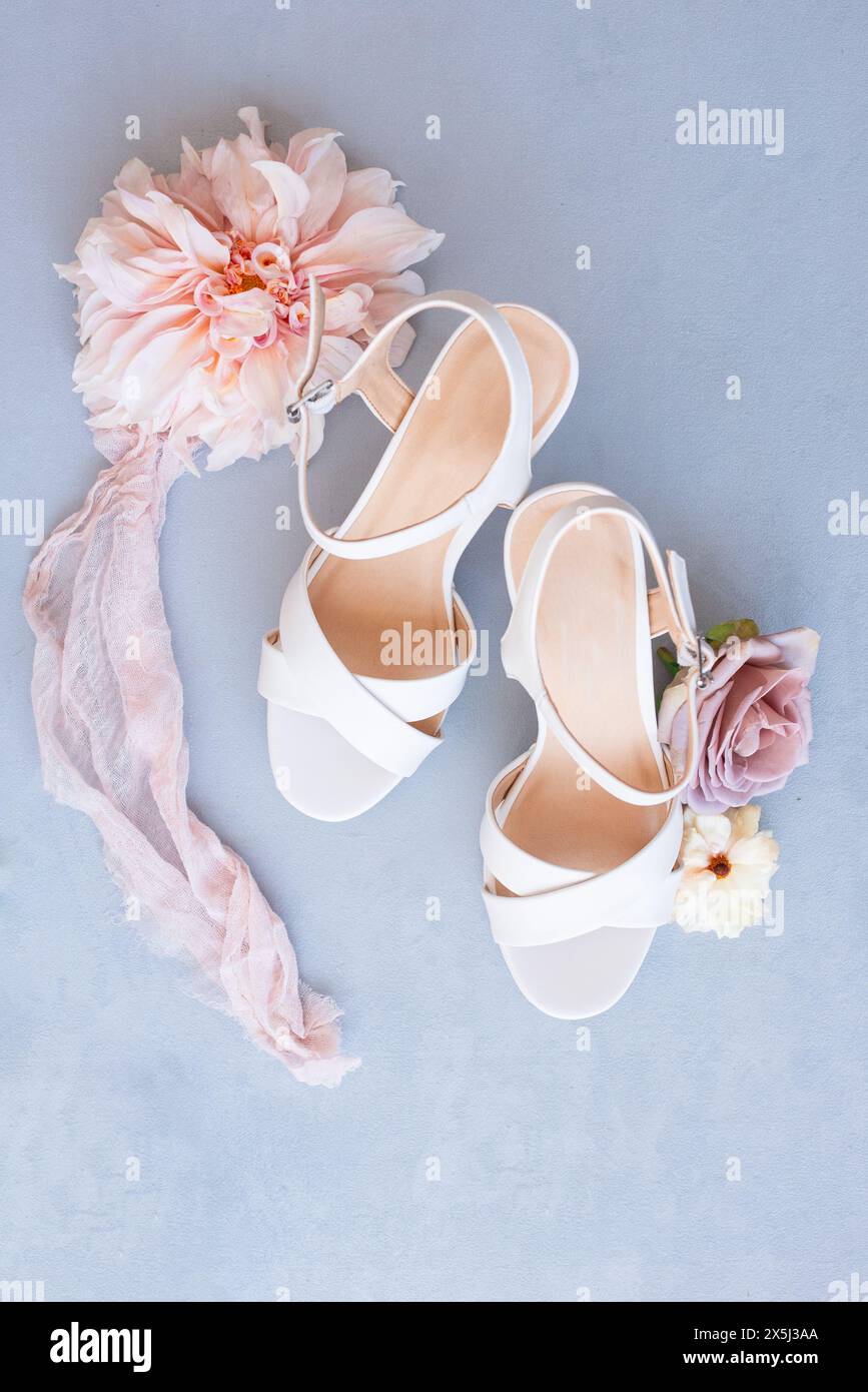 Elegant white wedding heels with pastel floral arrangement on so Stock ...