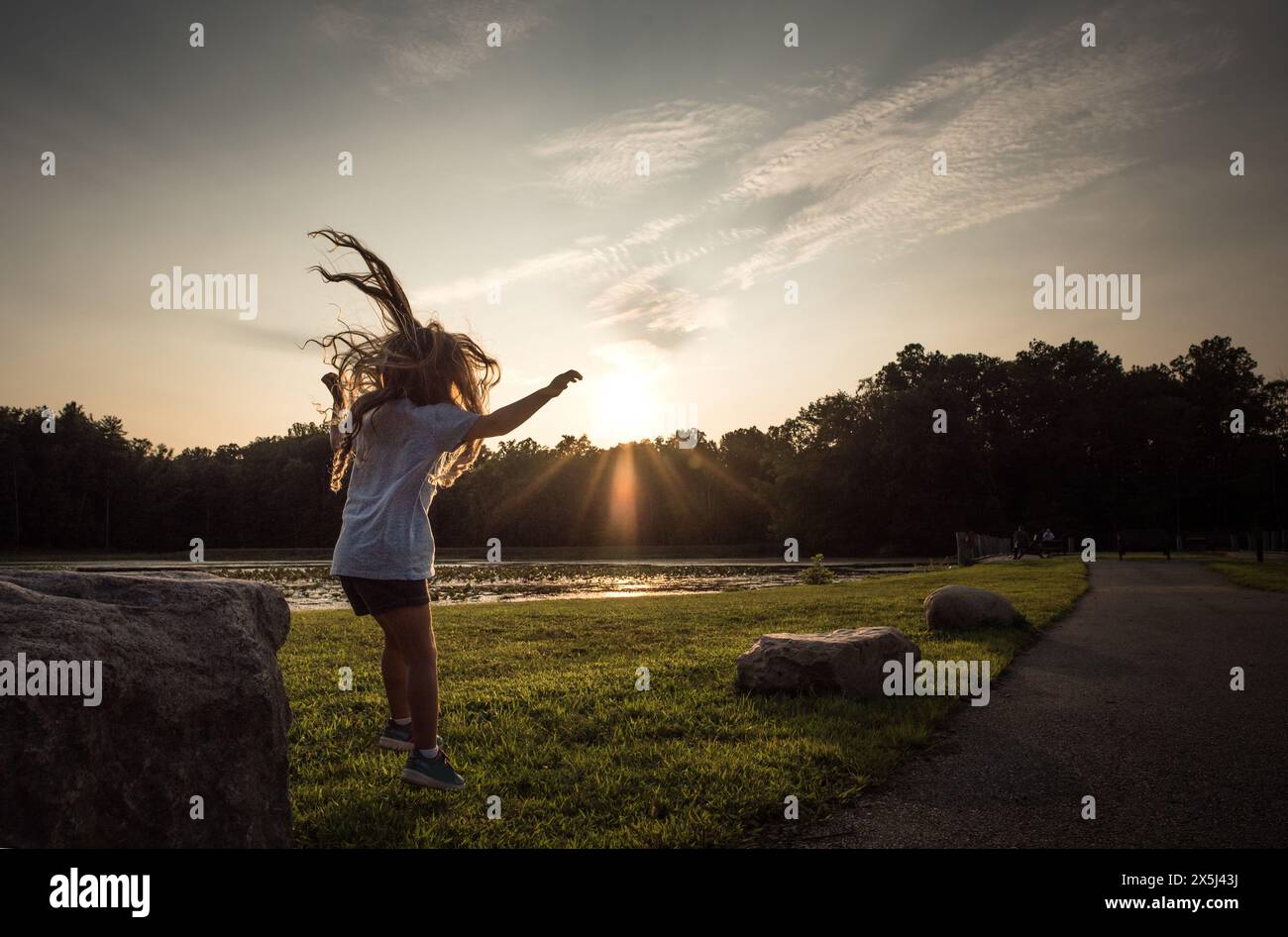 little girl falling off rock outdoors in summer Stock Photo - Alamy