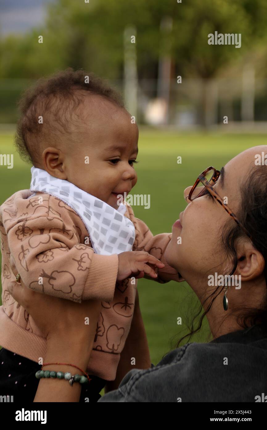 Loving black mother shares a tender gaze with her smiling baby Stock ...