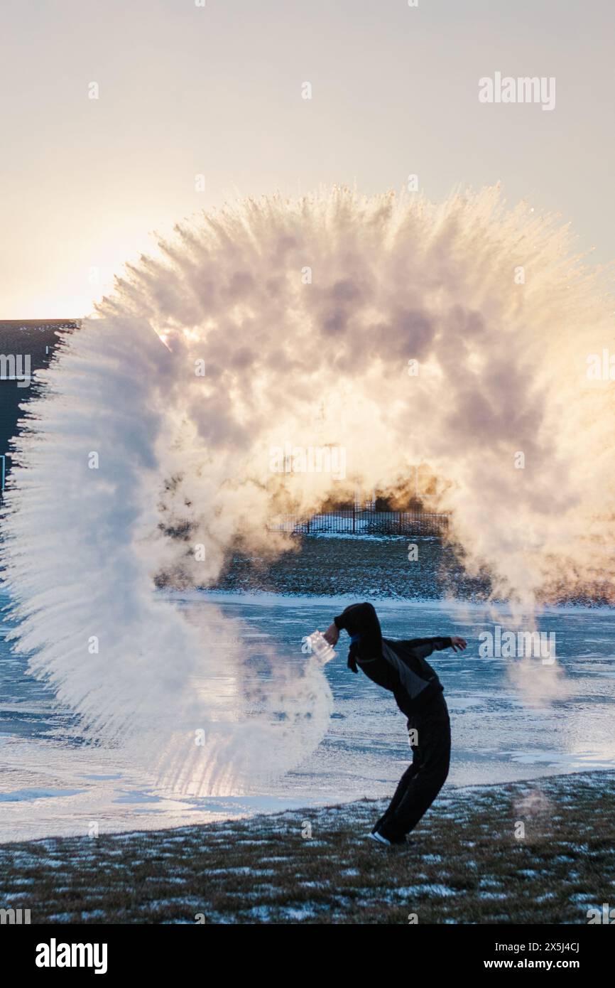 Silhouetted Art: Dramatic Winter Water Splash at Sunset Stock Photo - Alamy