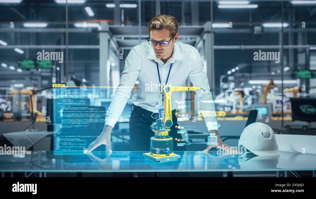 Industry 4.0 High-Tech Factory: Robotics Engineer Working on Robot Arm ...