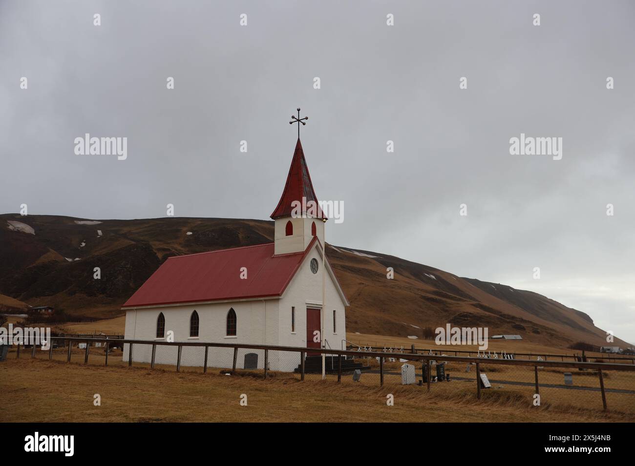 Red roofed church on mountainside near Vik and Reynisfjara, Iceland ...
