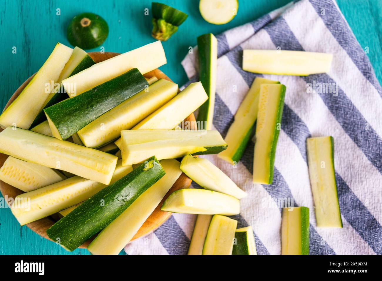 Fresh zucchini sticks prepped on vibrant teal background! Stock Photo ...