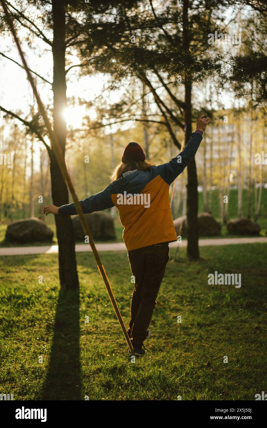 Athletic man trains on a slackline Stock Photo - Alamy