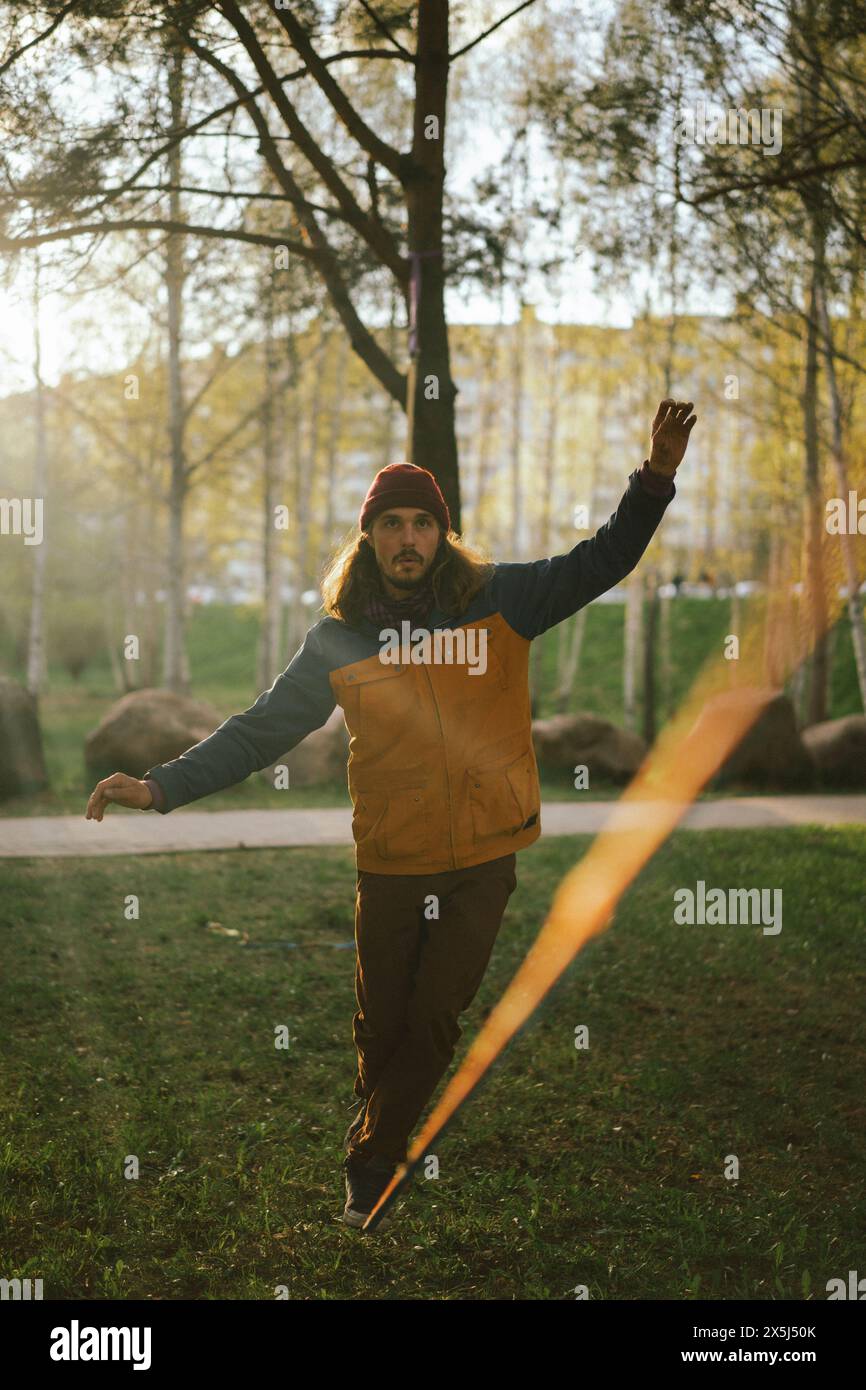 Athletic man trains on a slackline Stock Photo - Alamy