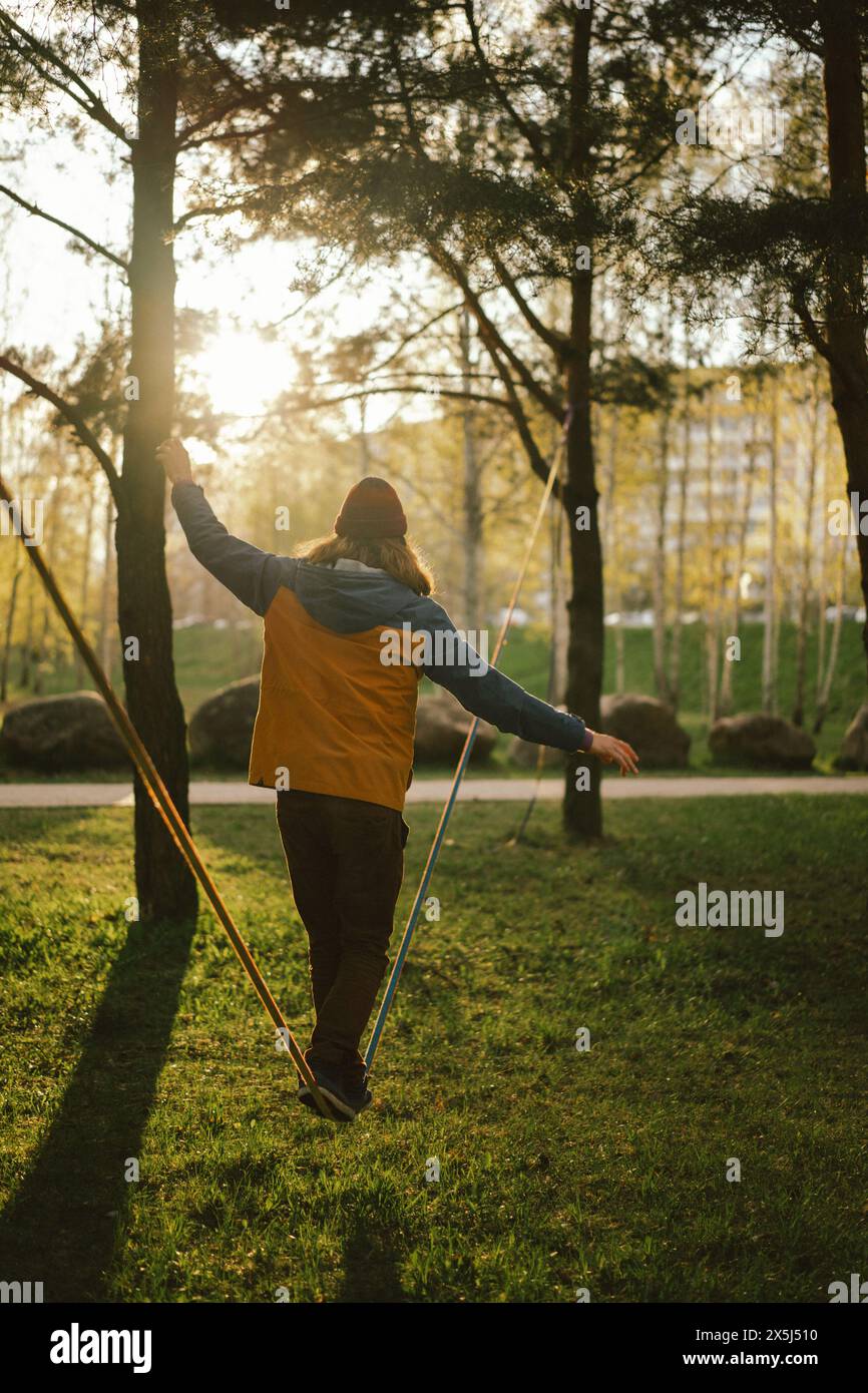 Athletic man trains on a slackline Stock Photo - Alamy