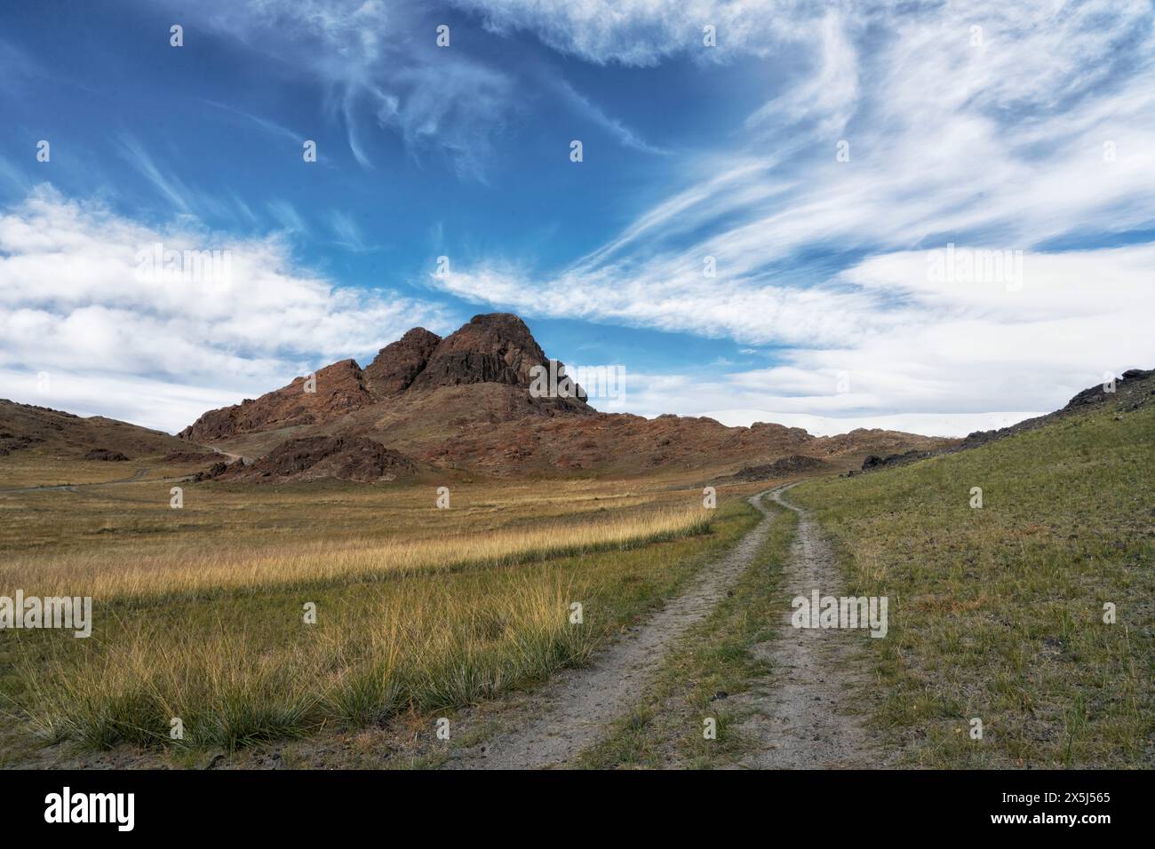 Asia, Mongolia, Bayan-Olgii Province. Rocky, rugged hills with grassy ...