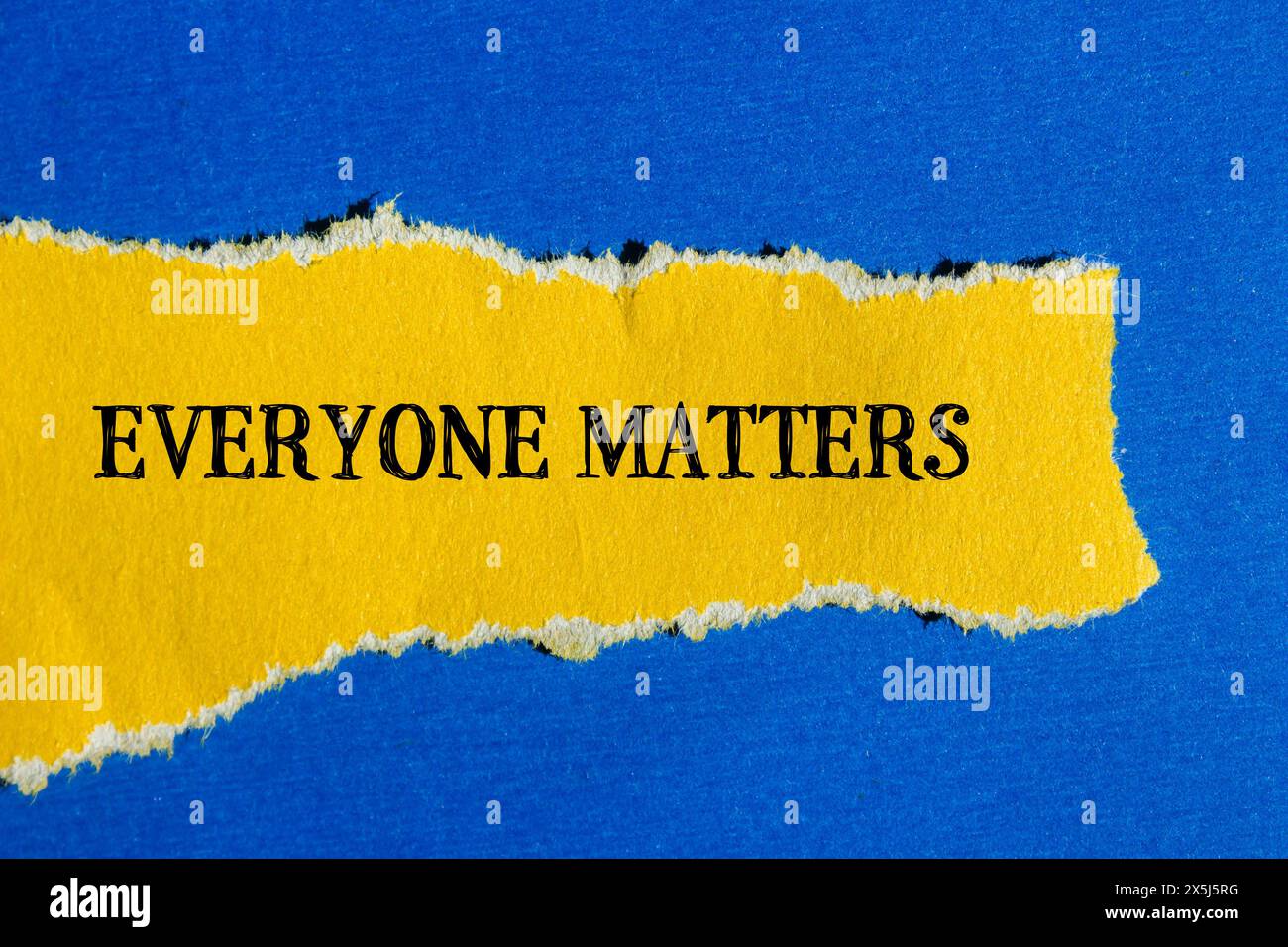 Everyone matters words written on ripped yellow paper with blue ... Everyone matters words written on ripped yellow paper with blue ...