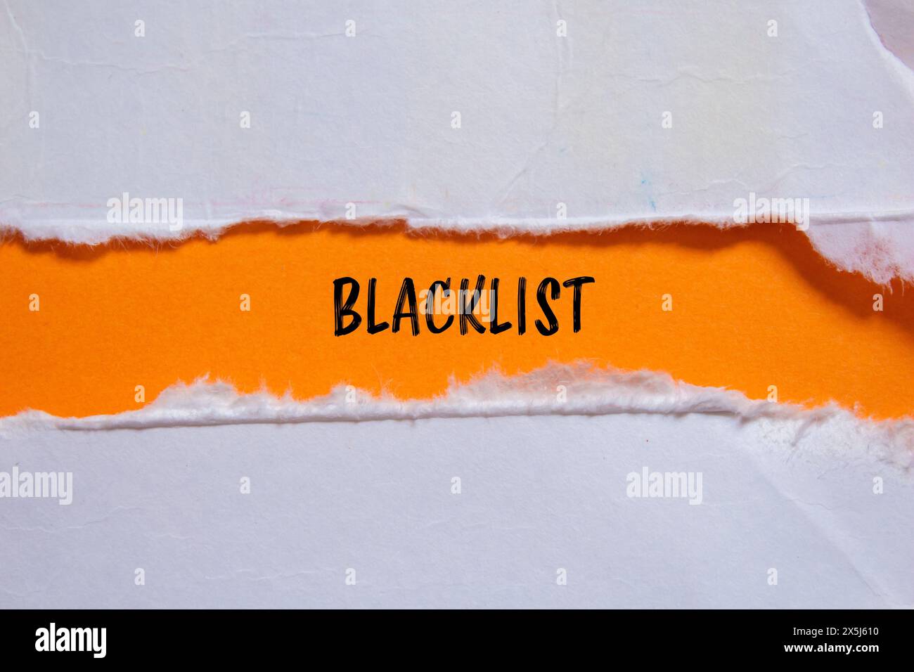 Blacklist word written on ripped paper with orange background ...