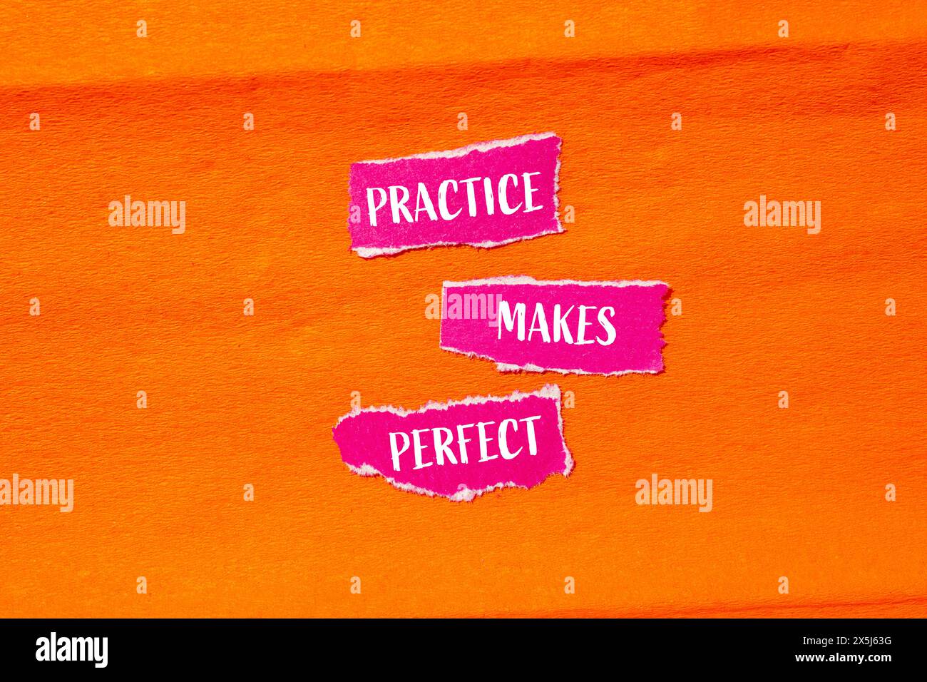 Practice makes perfect words written on ripped pink paper pieces with ...